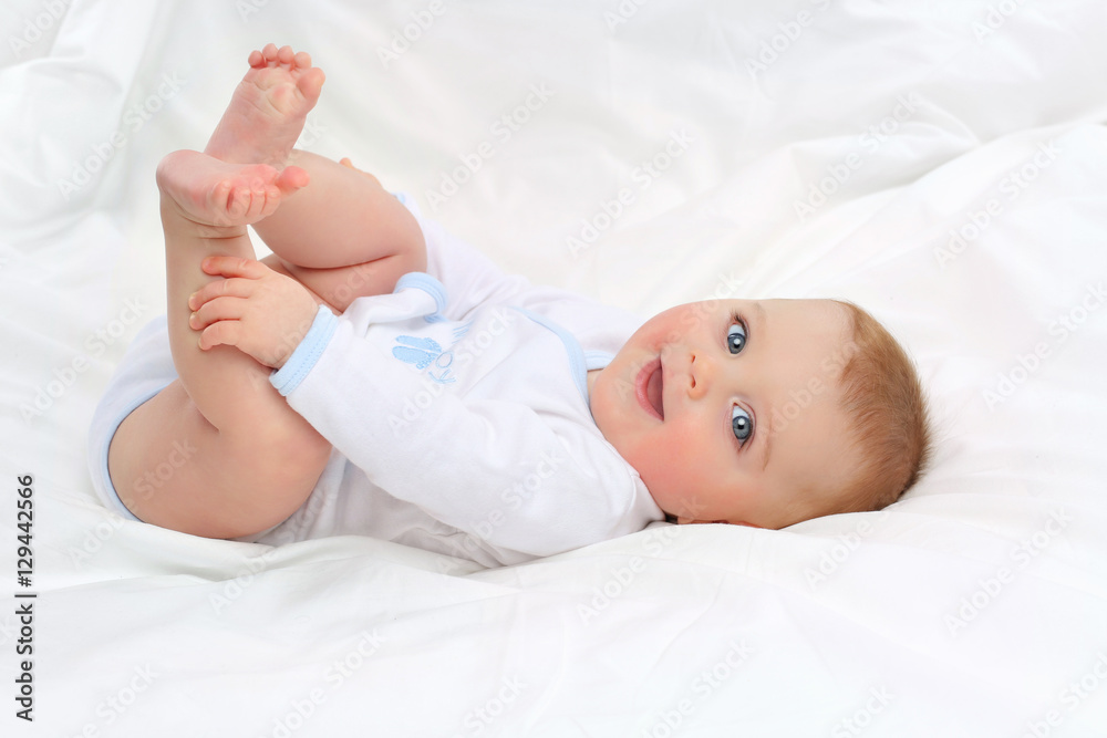 Baby in white bedding. Stock Photo | Adobe Stock