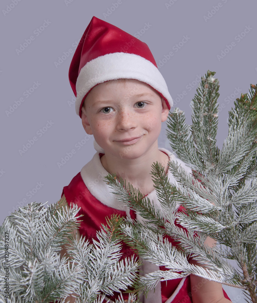 Little boy dressed up as Santa Claus, New Year.On a gray backgro Stock ...