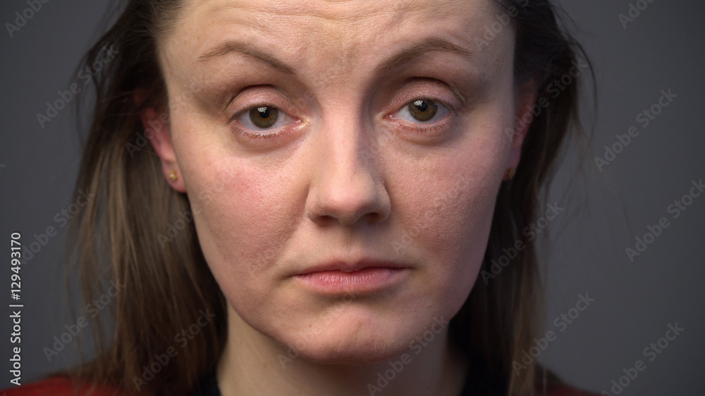 Close up sad adult woman's face against gray background Stock-Foto ...