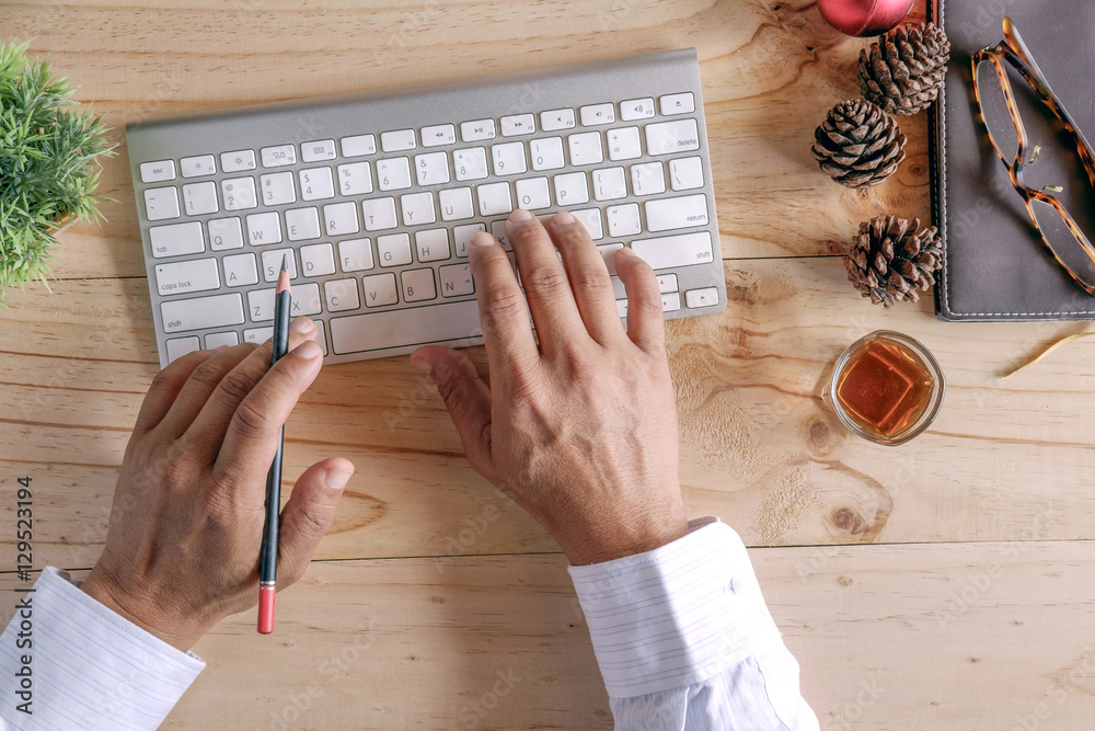 Man typing keyboard PC and office supplies, Work space on desk wood top ...
