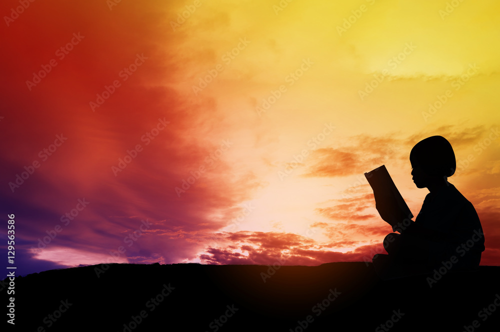 Silhouette children girl reading book on sky sunset background.kids ...