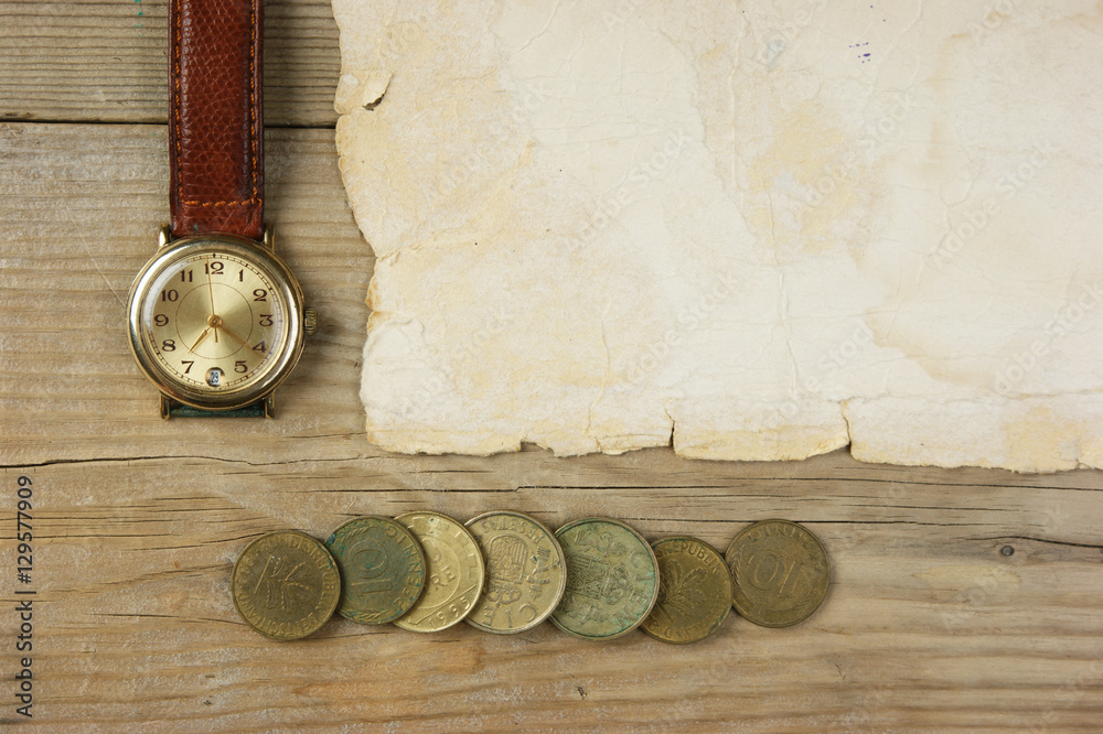 Old paper and coins on a wooden table Stock Photo | Adobe Stock