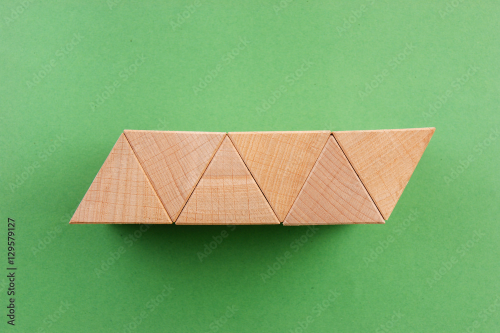 wooden geometric shapes on a green background Stock Photo | Adobe Stock