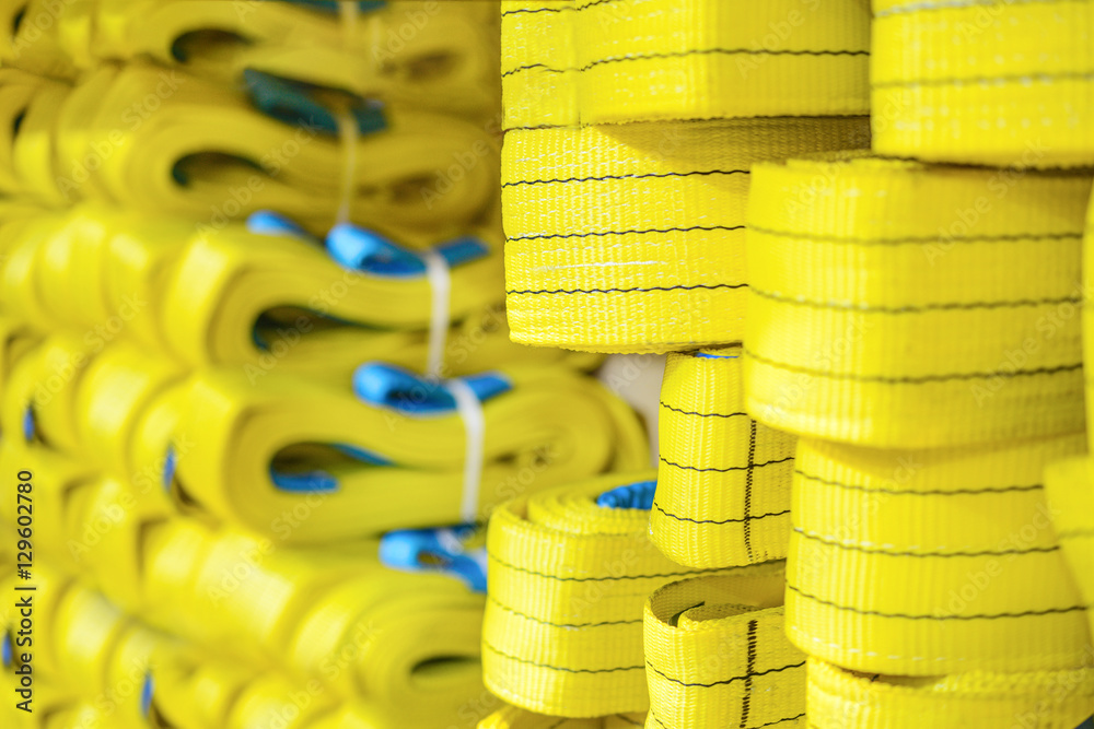 Yellow nylon soft lifting slings stacked in piles. Stock Photo | Adobe ...