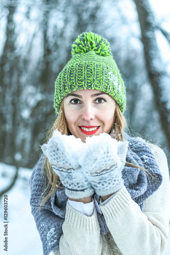 Beautiful girl fun outdoor in winter forest under snowflakes. holding a ...