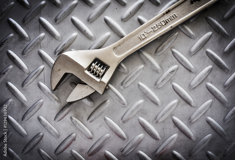 Adjustable wrench, mechanics hand tool on steel checker plate ...
