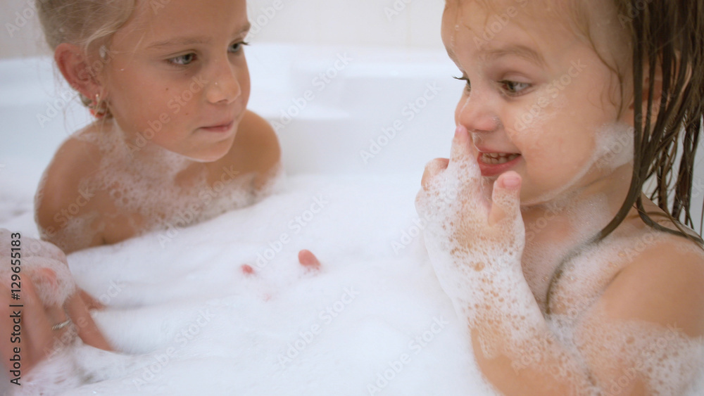 Two cute little sisters bathing in the bath Stock Photo | Adobe Stock