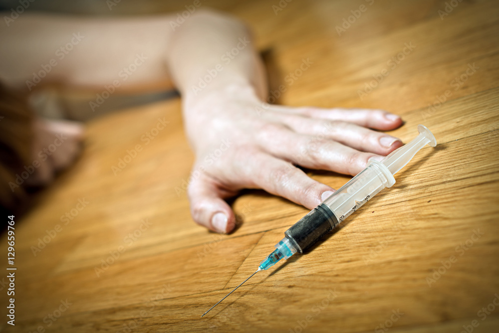 Syringe with heroin in front of drug addict female. Stock Photo | Adobe ...