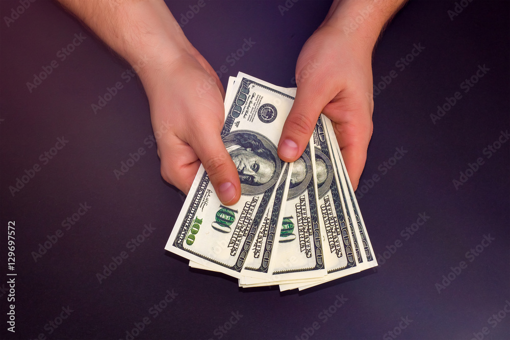 Man counting money. Male hand holding a wad of money. Stock Photo ...