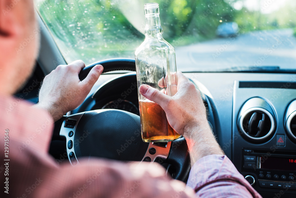 Man drinking alcohol in the car. Stock-Foto | Adobe Stock