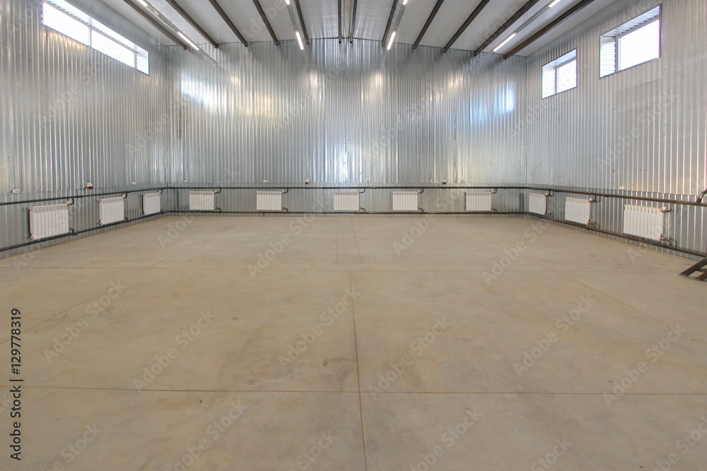 empty parking garage, warehouse interior with large white gates and ...