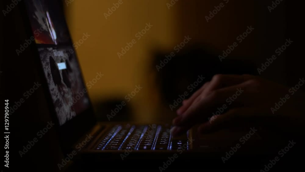 young woman opens laptop, her fingers is typing text very fast on ...