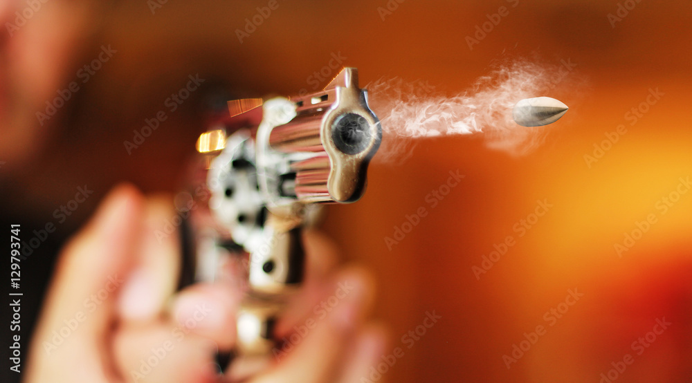 hand gun revolver with flying bullet fire Stock Photo | Adobe Stock