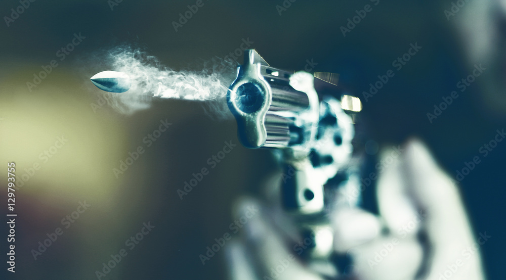 hand gun revolver with flying bullet fire Stock Photo | Adobe Stock