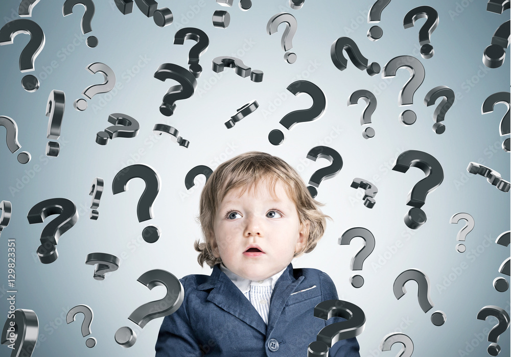 Baby boy and question marks on gray wall Stock Photo | Adobe Stock
