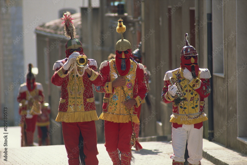 Trumpet players in red costumes and horse tails celebrate the Feast of ...