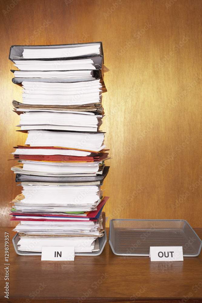Inbox with stack of paperwork empty outbox on desk Stock Photo | Adobe ...