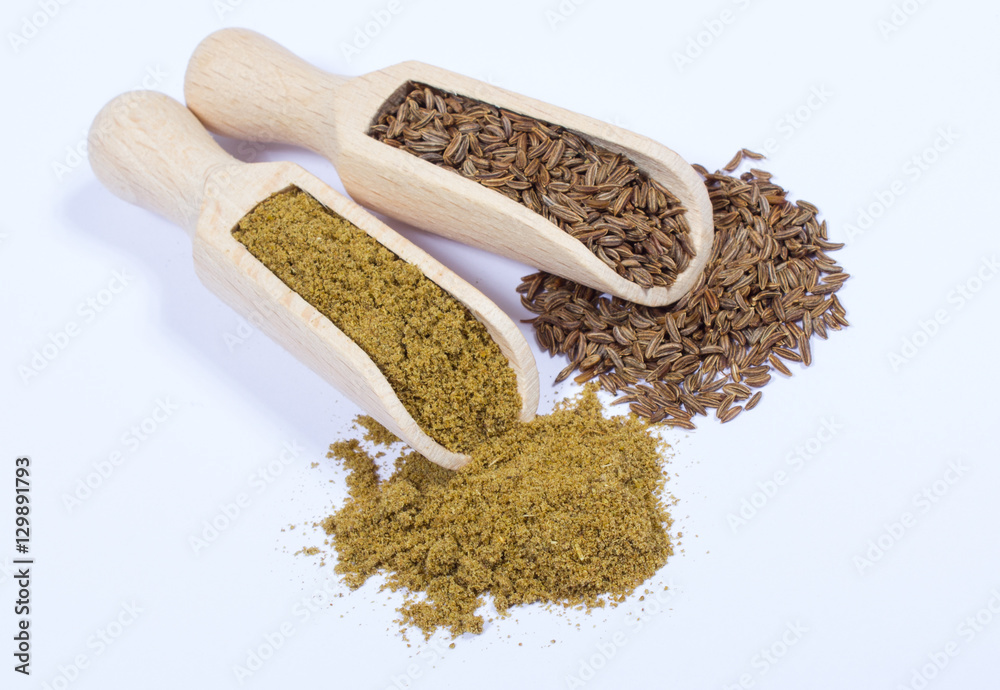 Ground cumin in a spoon and whole cumin. Stock Photo | Adobe Stock