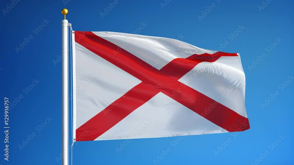 Alabama (U.S. state) flag waving in slow motion against blue sky ...