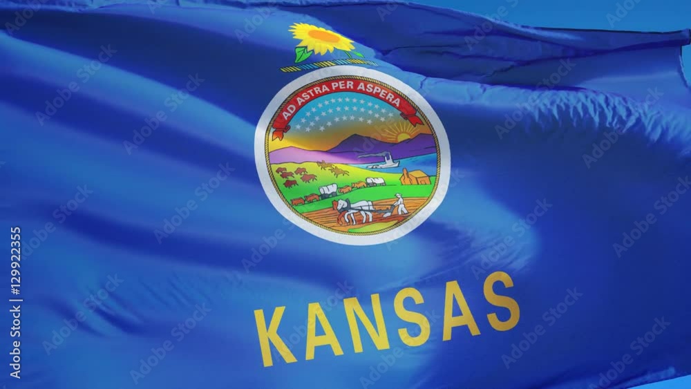 Kansas (U.S. state) flag waving in slow motion against blue sky ...