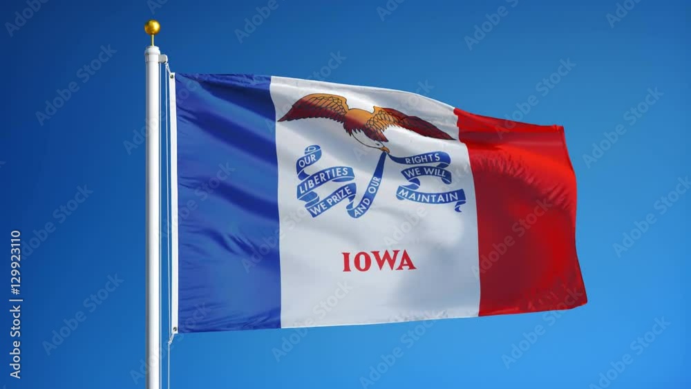 Iowa (U.S. state) flag waving in slow motion against blue sky ...