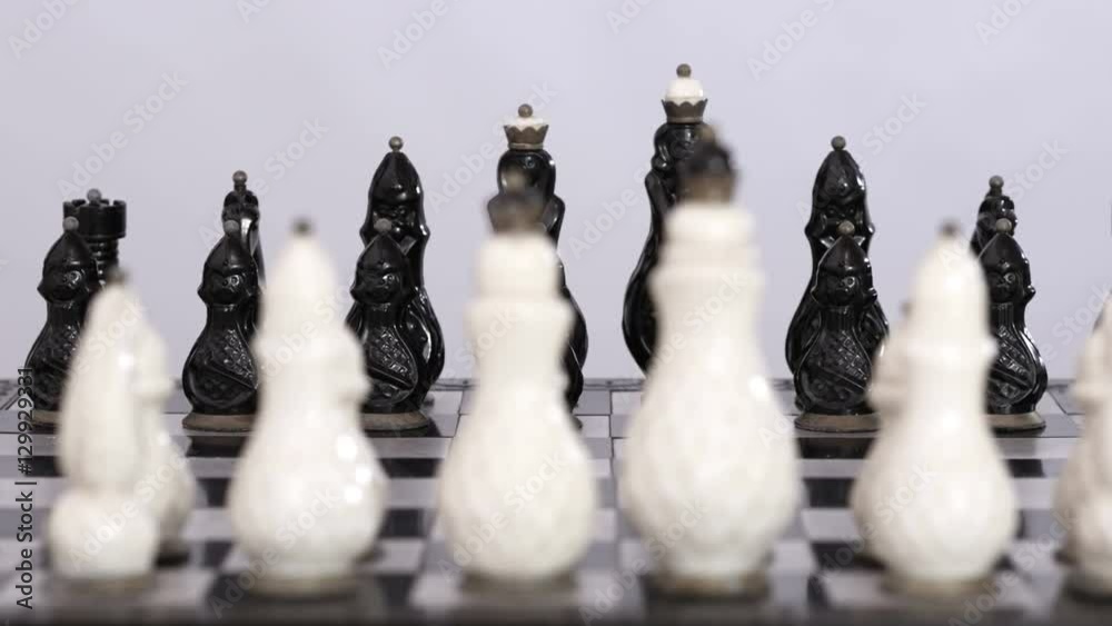 White and black chess set up for game, movement from left to right side ...