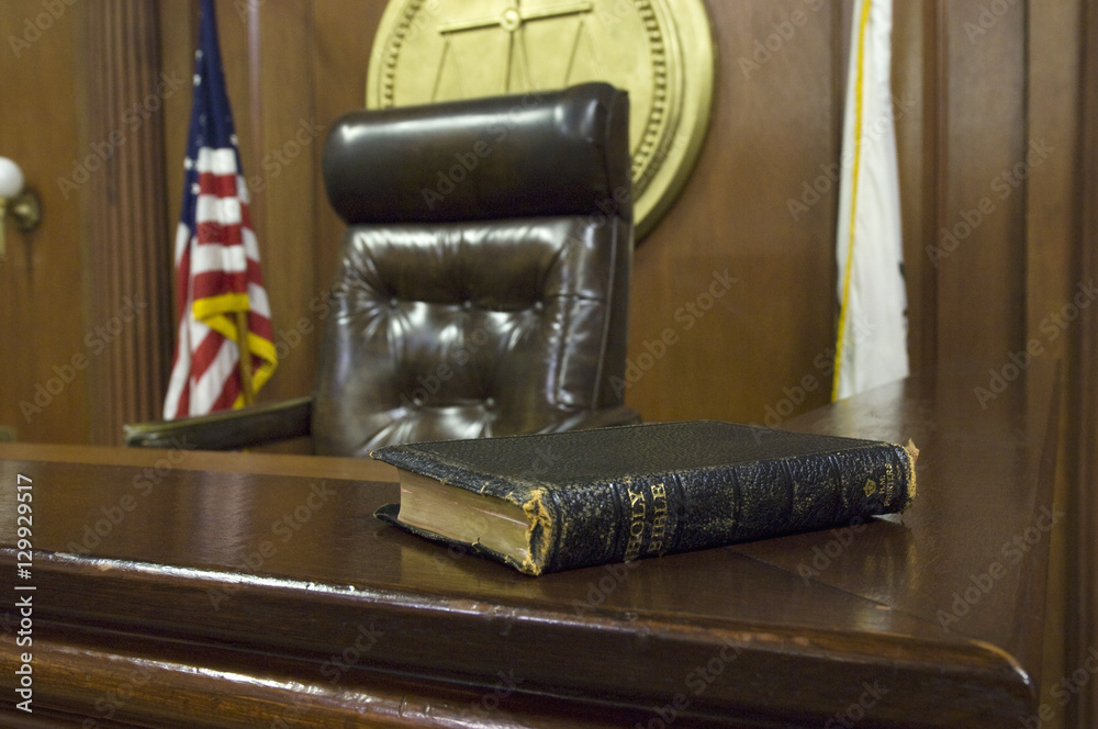 Holy Bible on table beside judge's chair in courtroom Stock Photo ...