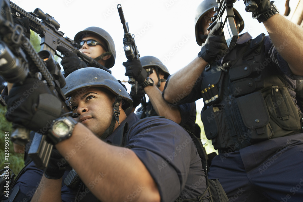Group of police officers aiming with guns Stock Photo | Adobe Stock