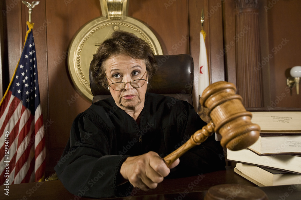 Female Judge Knocking A Gavel In Courtroom Stock Photo Adobe Stock