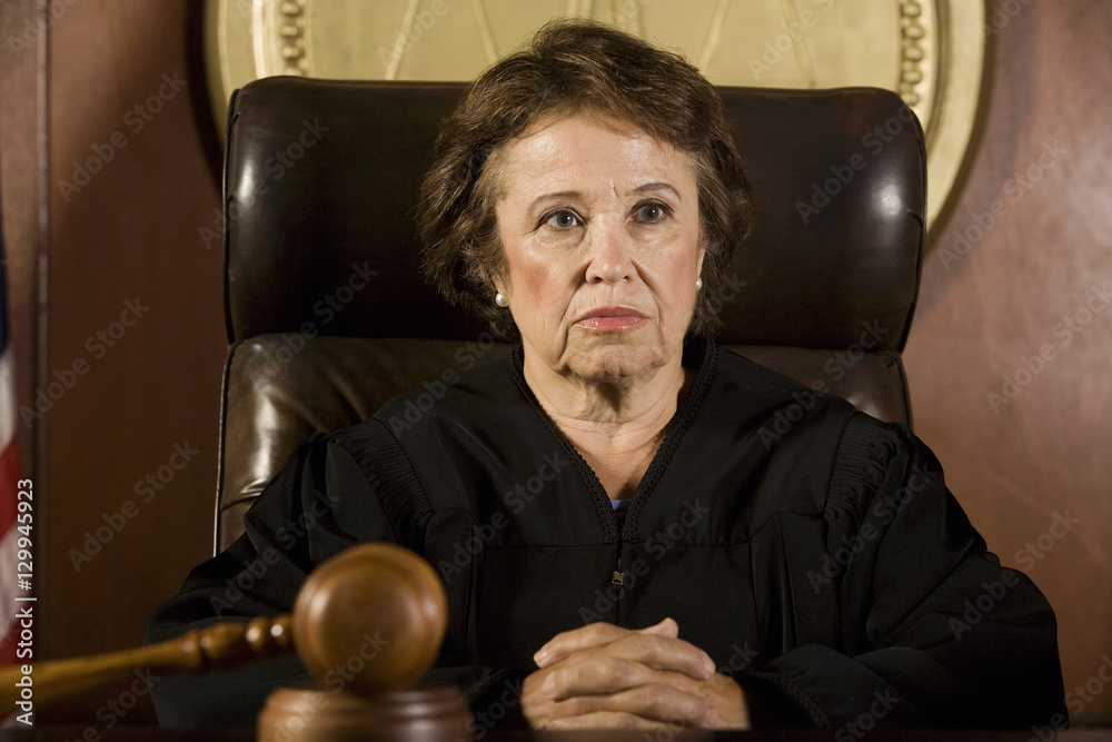Female judge pondering over sentence in courtroom Stock Photo | Adobe Stock