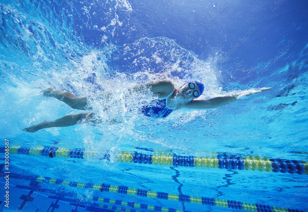 Female swimmer in United States swimsuit while swimming in pool Stock ...