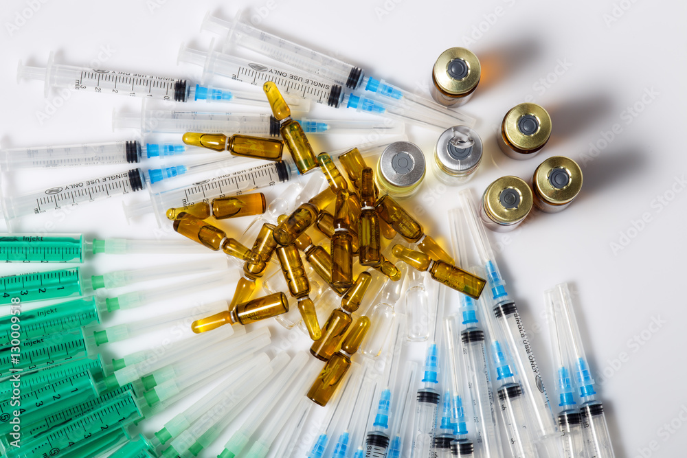 Stock of 5 ml,3 ml medical syringes and vials with liquid drugs. Green ...