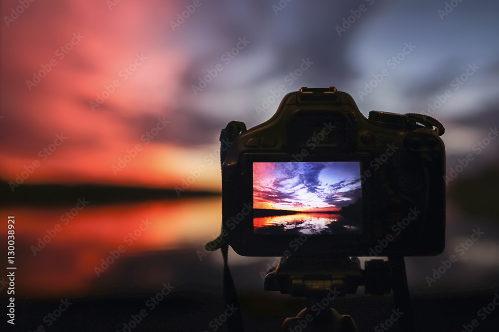 Camera capturing sunset. Photography view landscape. Camera the night ...