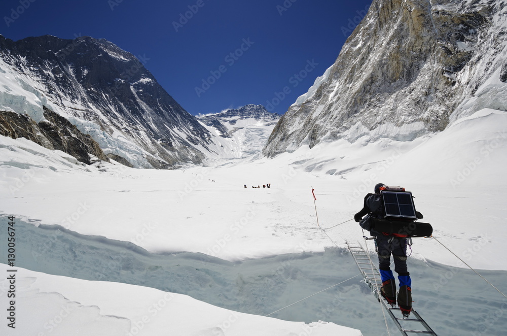 Climbers crossing crevasse and ladder on Mount Everest, Solu Khumbu ...