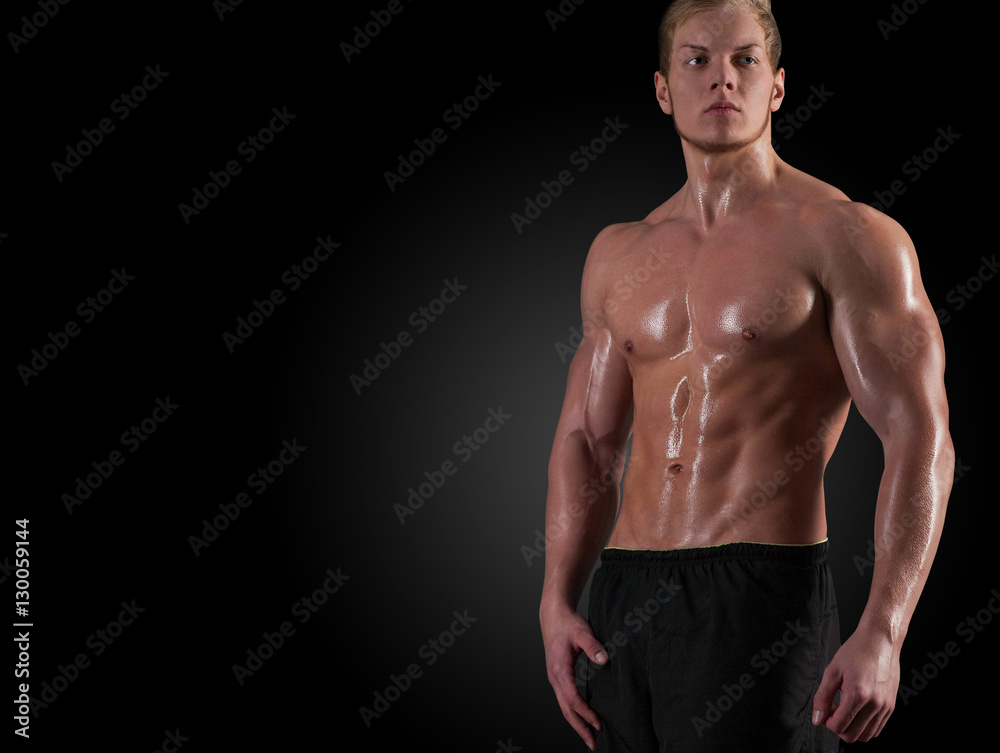 Handsome young man with perfect body muscles and biceps. Close-up of a ...