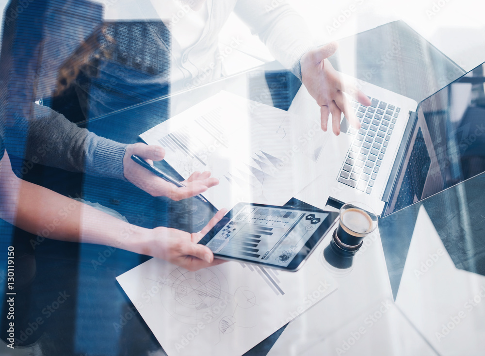 Young team working together with modern electronic devices in coworking ...