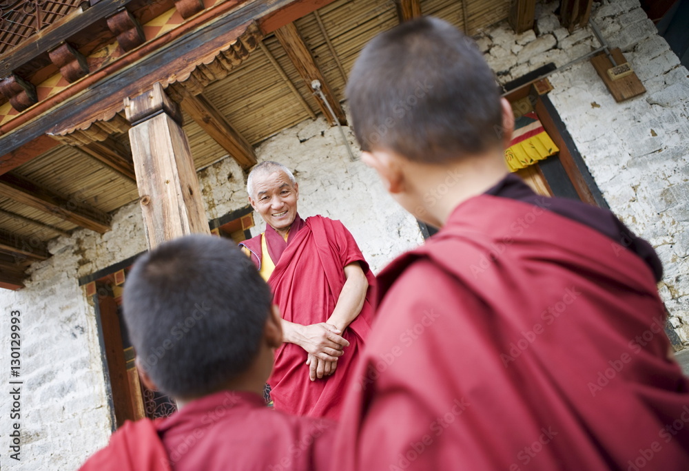 Buddhist lama teaching young monks, Karchu Dratsang Monastery, Bumthang ...