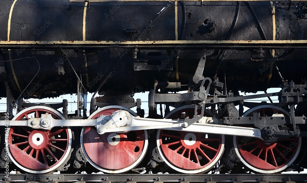 Red wheels of old USSR black steam locomotive. Wheels of an old soviet ...