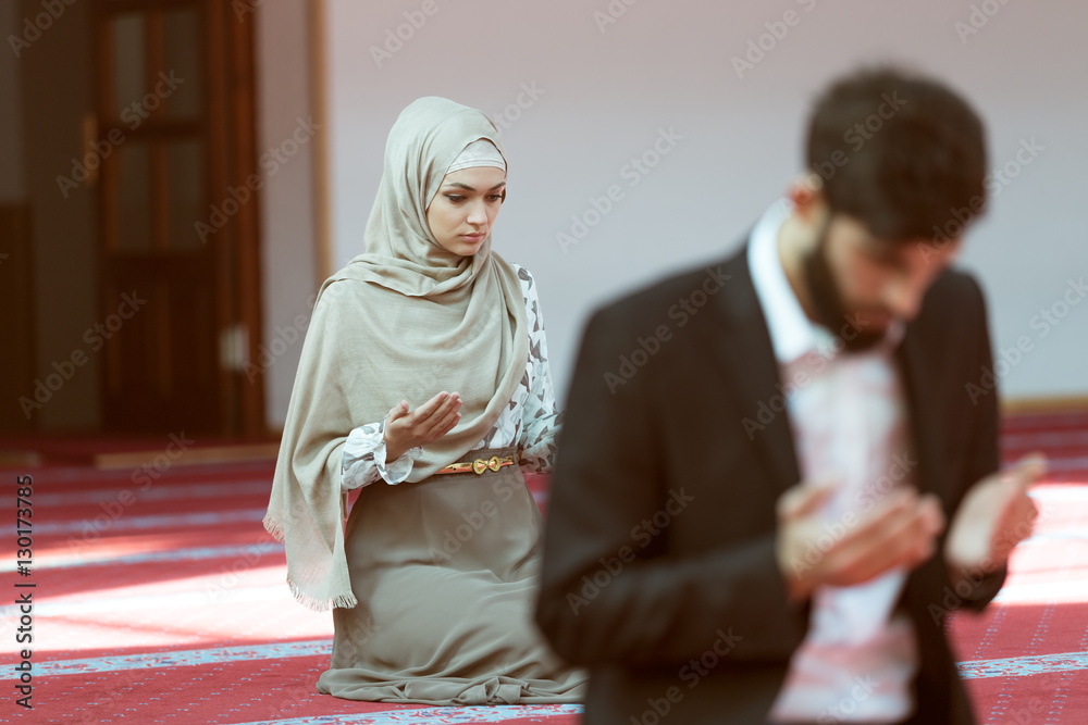 Muslim man and woman praying in mosque Stock Photo | Adobe Stock