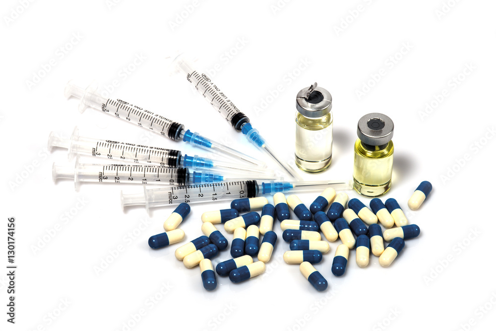 Stock of pills, syringes and vials with liquid drugs. White blue ...