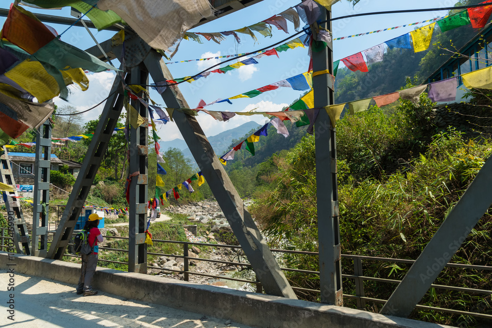 travelers at bridge to Poon Hill , Nepal. old metal truss bridge. Stock ...