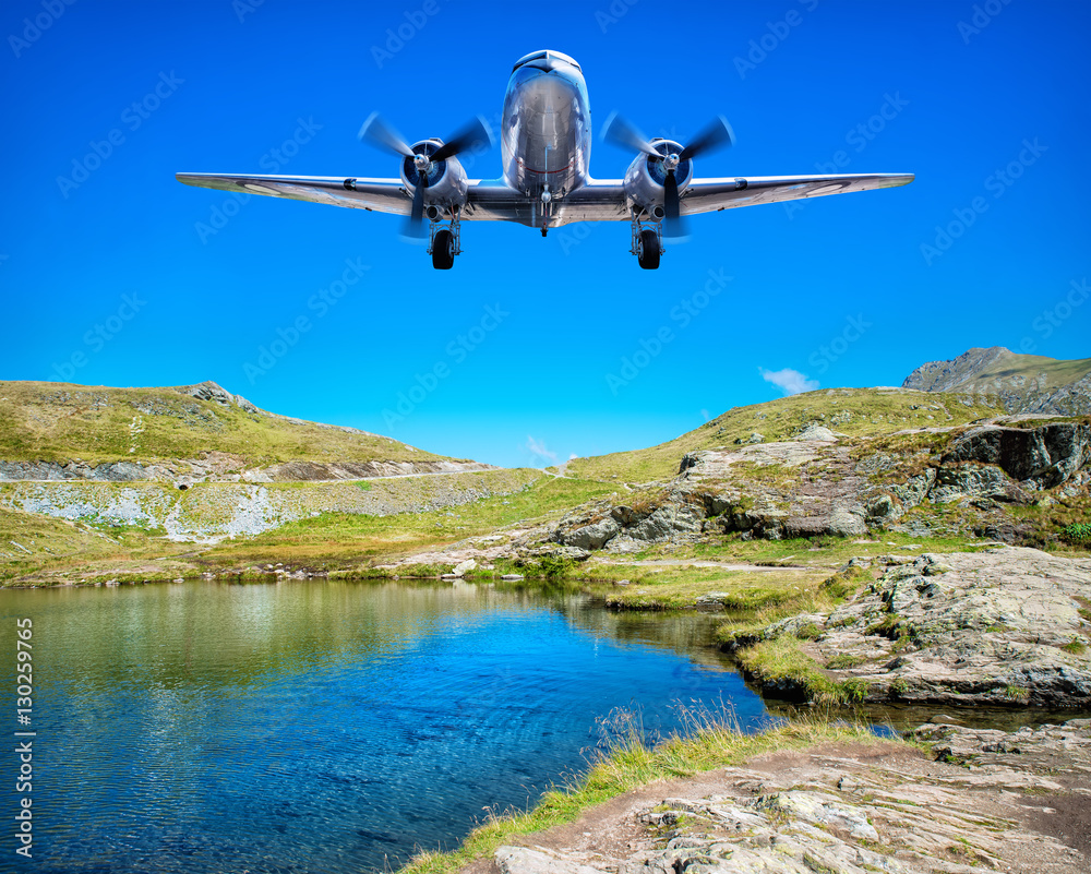 airplane flying over a lake in the mountains Stock Photo | Adobe Stock