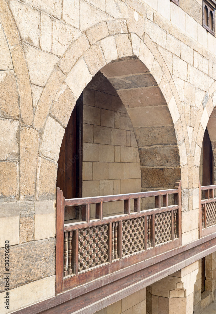 Angled view of one arch with interleaved wooden balustrades at the ...