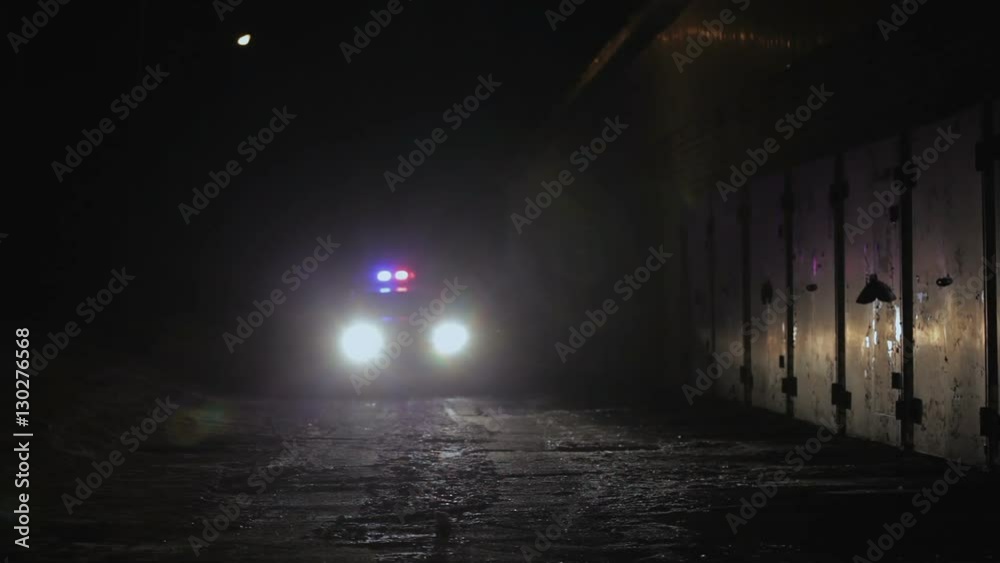 Police car patrolling the city at night. Patrolling in the dark areas ...