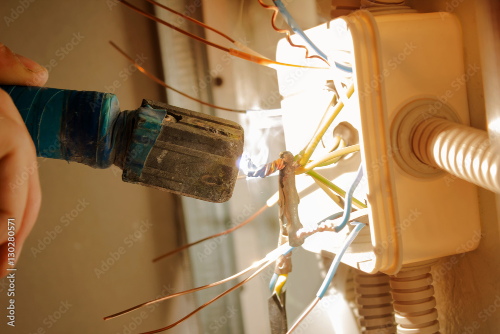 Welding electrical wires in junction box Stock Photo | Adobe Stock