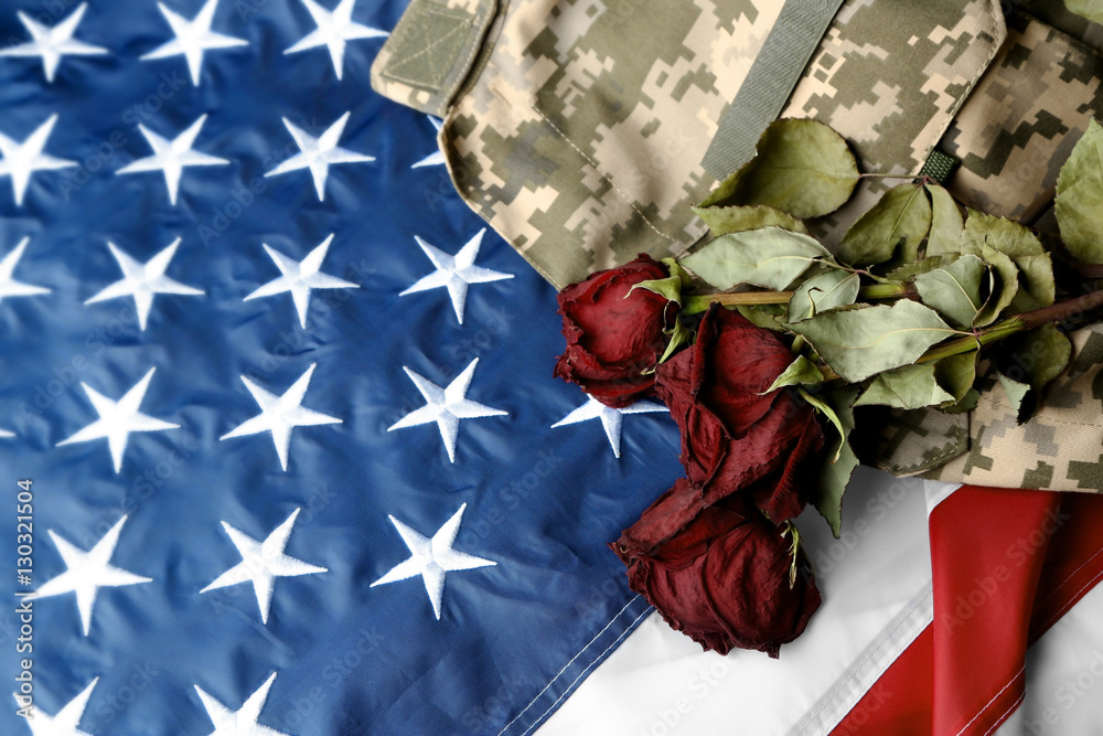 Dried roses and military uniform on American national flag. Veterans ...