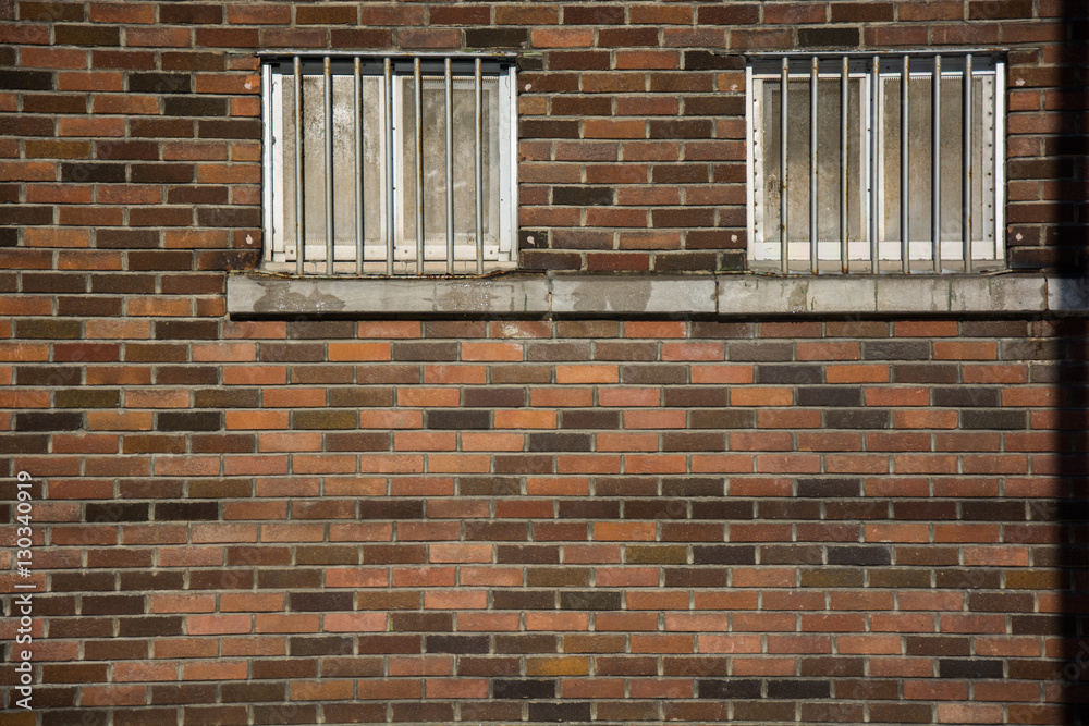 A jail windows with bars, in a brick wall. There is room for text ...