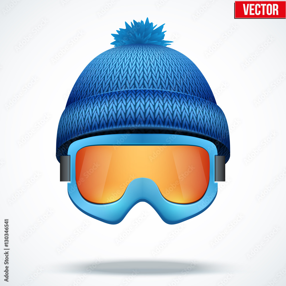 Knitted woolen blue cap with snow ski goggles. Winter seasonal sport ...