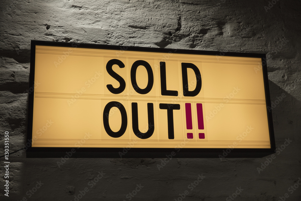Close-up of Sold Out signboard against gray wall Stock Photo | Adobe Stock