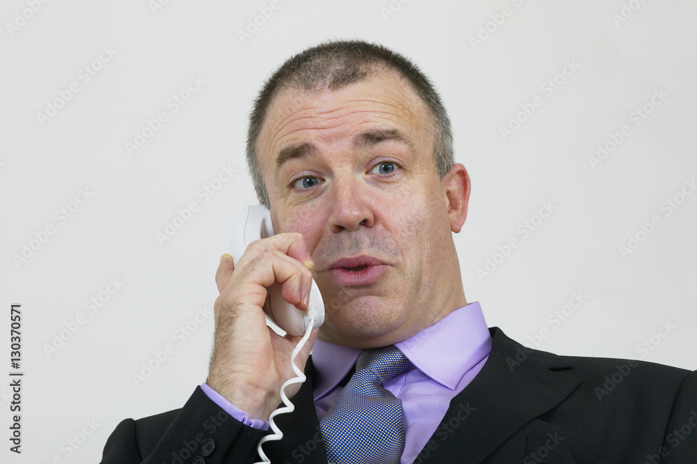 Businessman having confused conversation on telephone Stock-Foto ...